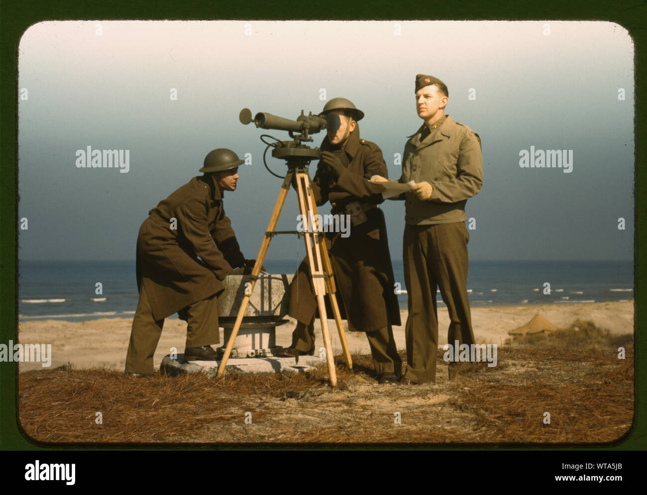 Men of Fort Story operate an azimuth instrument, to measure the angle ...