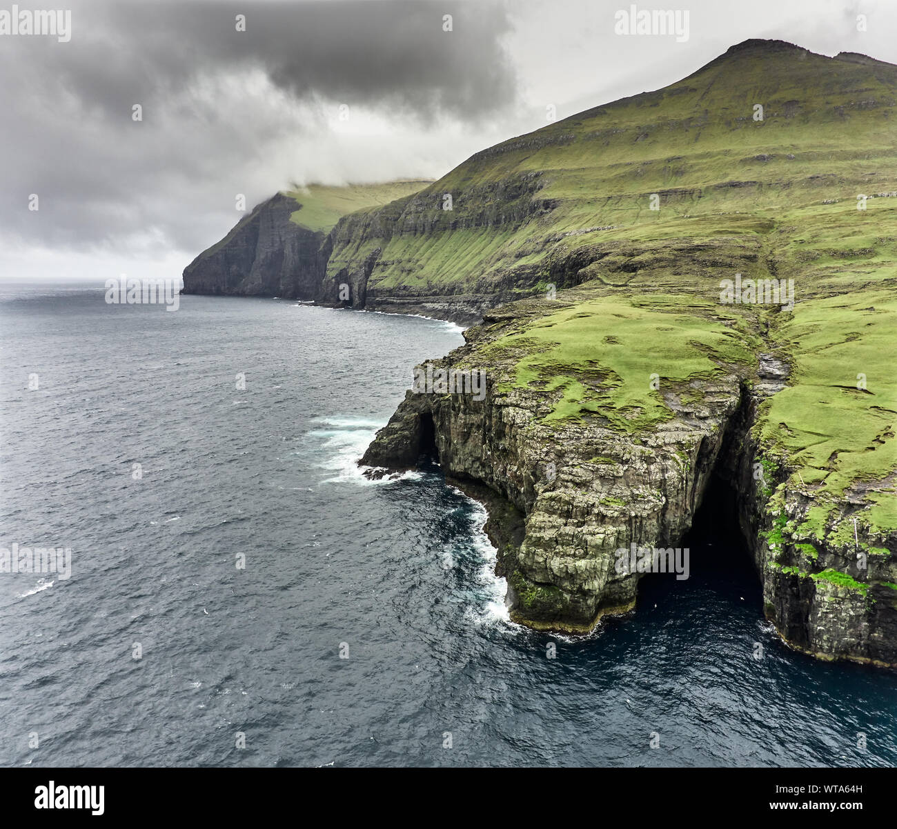 Scenic view of green field on cliff on Faroe Islands Stock Photo - Alamy