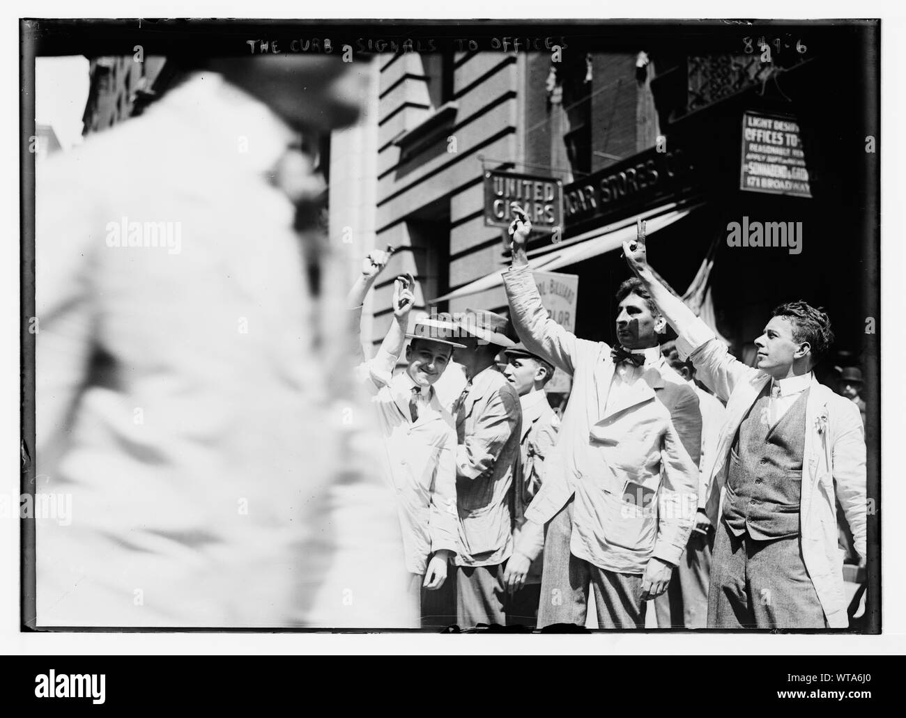 Men on curb, signals to offices Stock Photo - Alamy