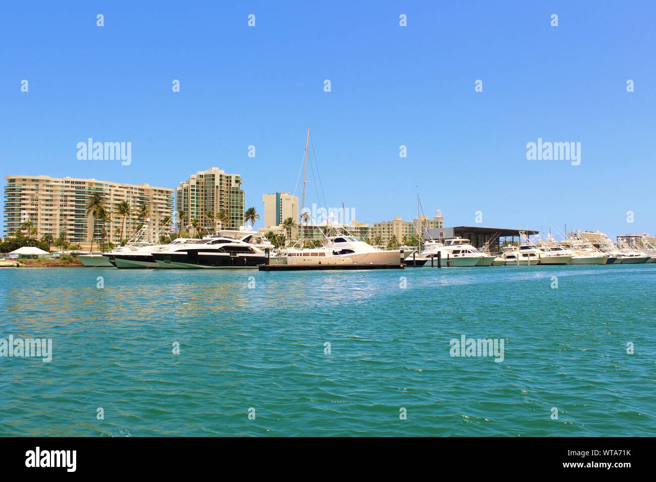 Boats and Yachts moored up on a sunny summers day in San Juan Bay ...