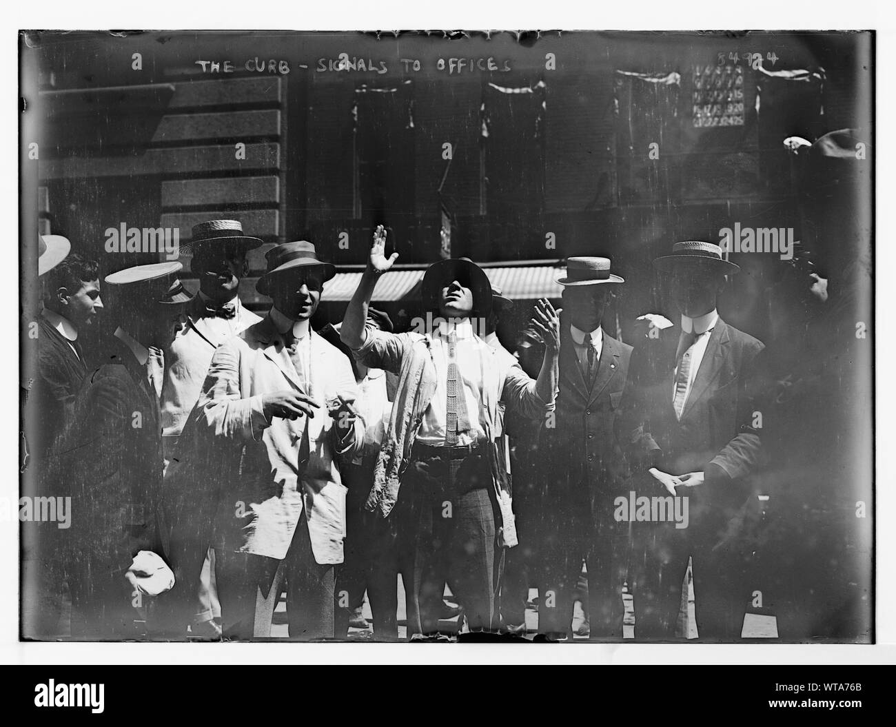 Men on the curb-signals to offices Stock Photo - Alamy