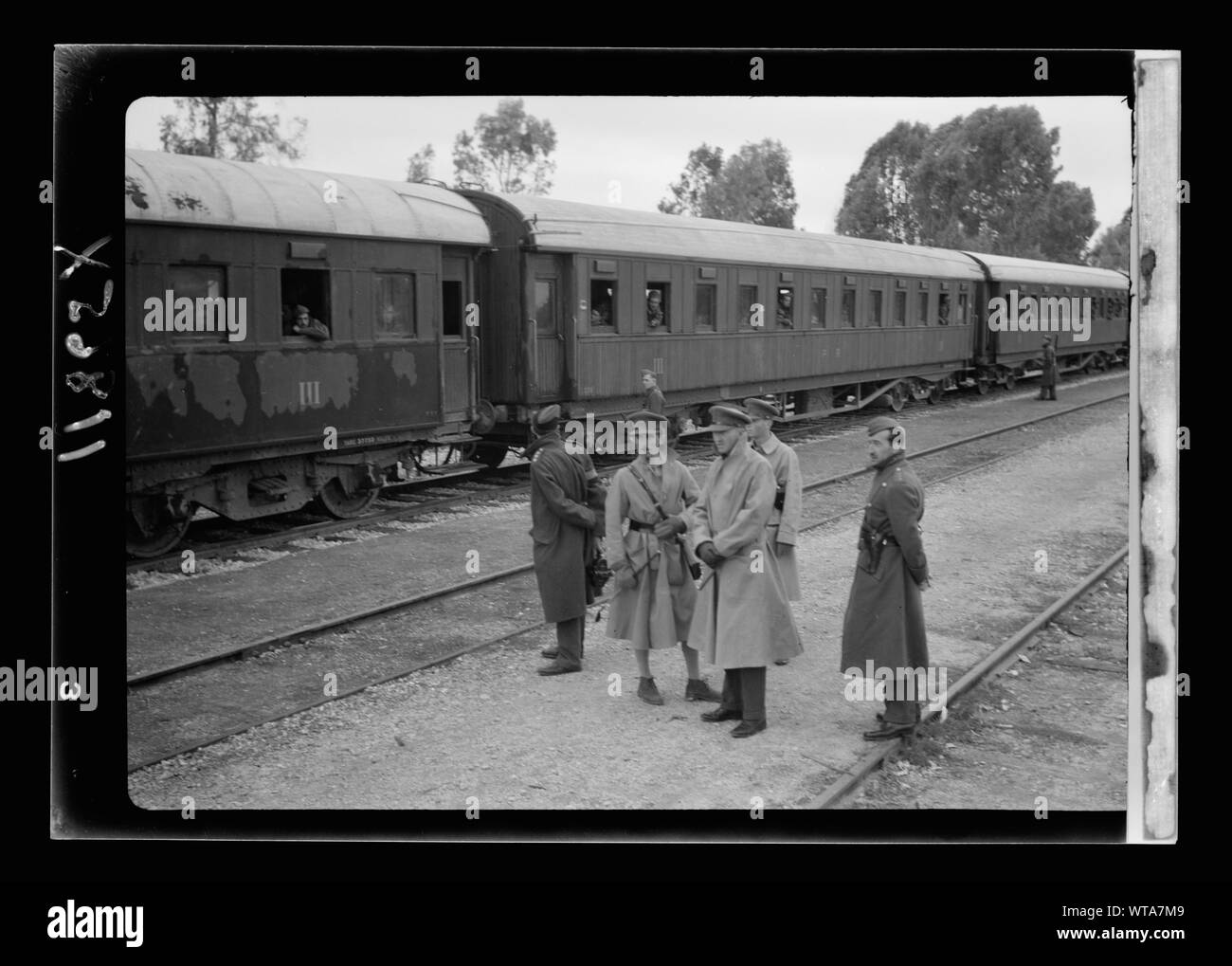 Men standing beside train Stock Photo - Alamy