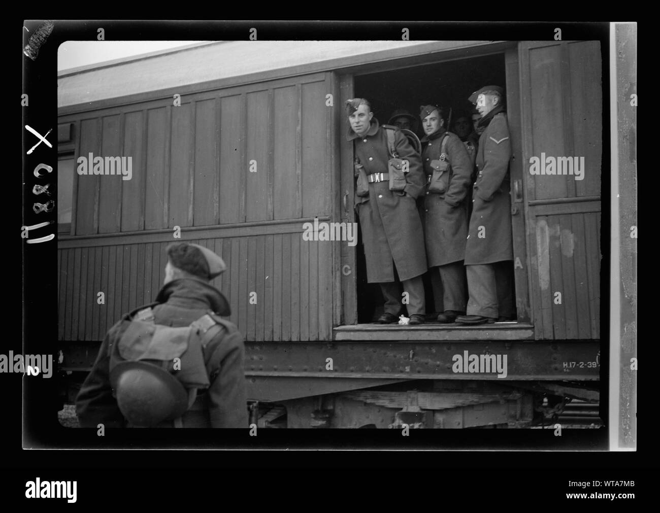 Men standing in opening of train car Stock Photo - Alamy