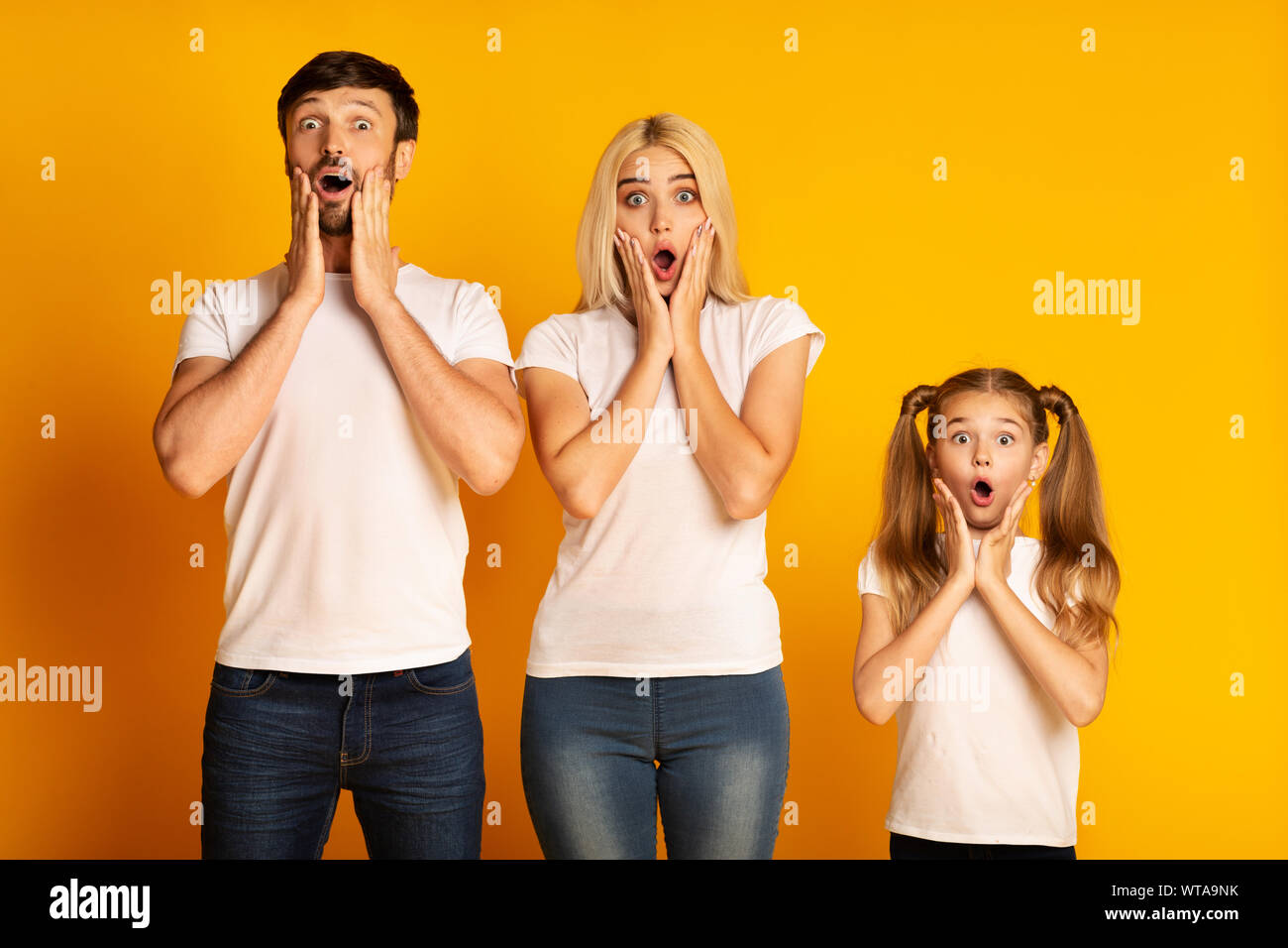 Shocked Parents And Daughter Looking At Camera With Open Mouth Over ...