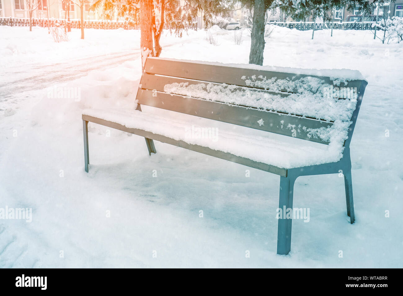 Garden bench in the Park in the winter snowfall. Seasonal phenomenon ...