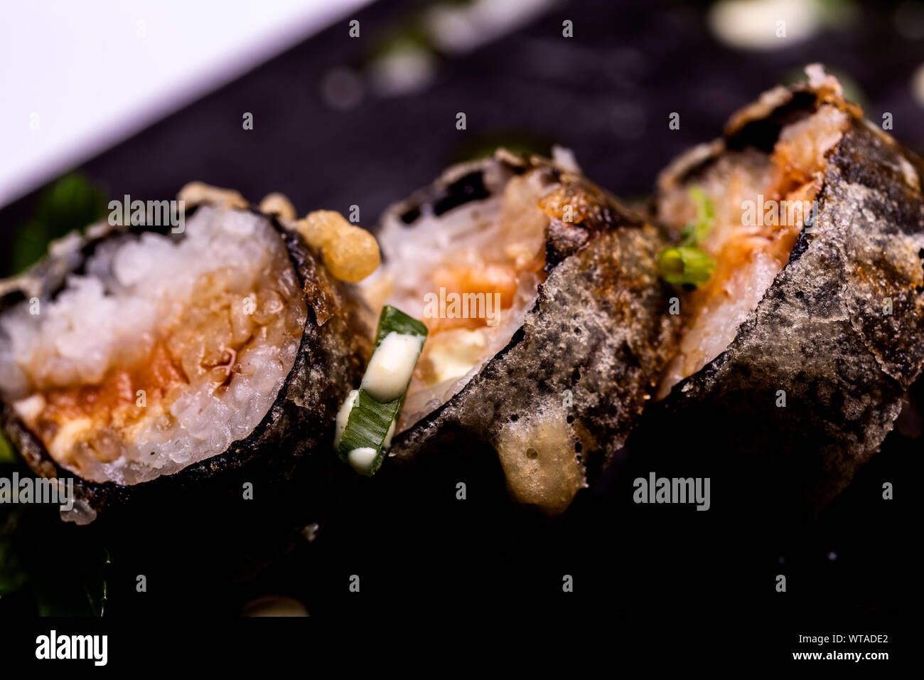 Sushi Roll viewed from above. On black stone Stock Photo - Alamy