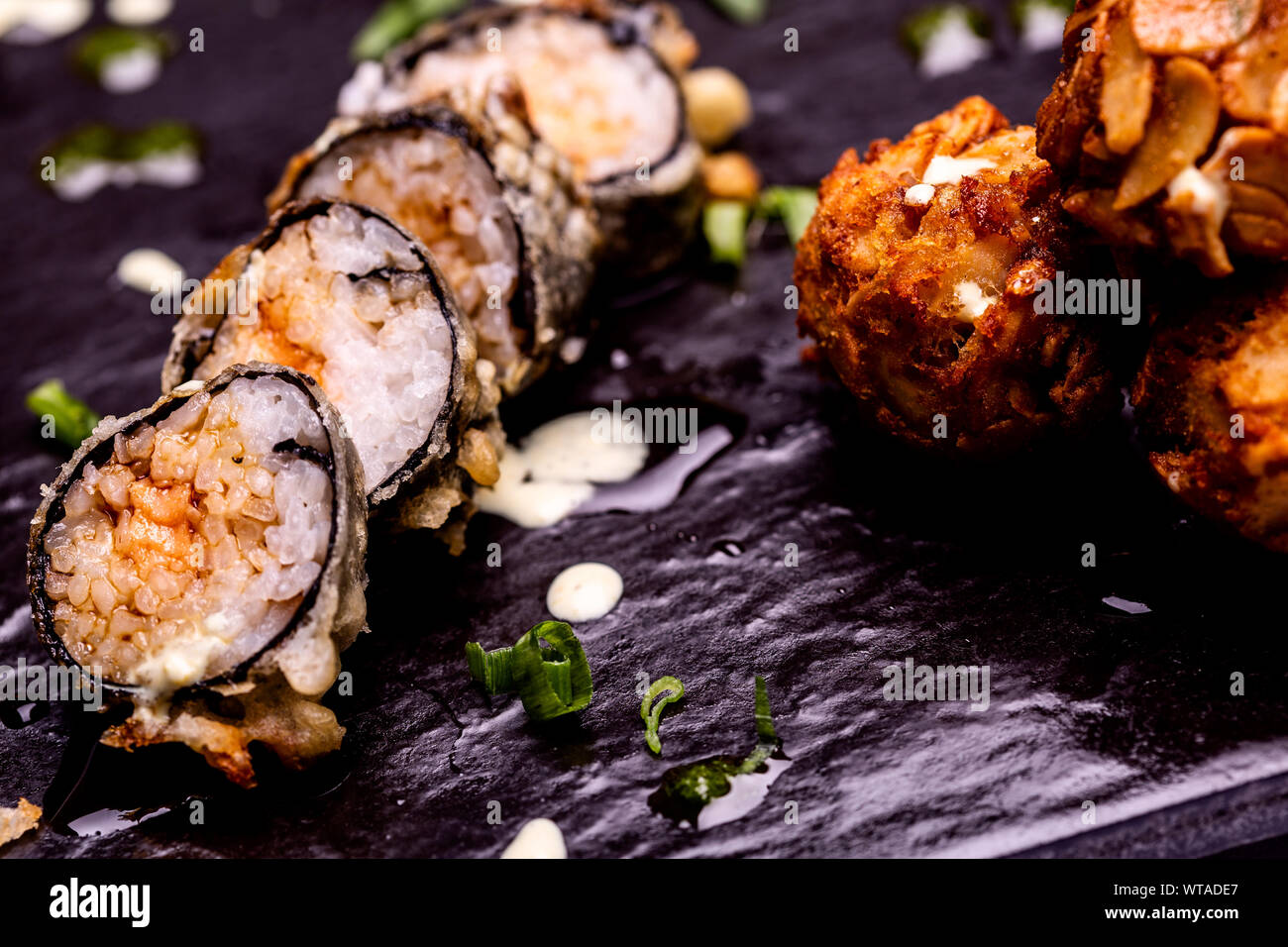 Sushi Roll viewed from above. On black stone Stock Photo - Alamy