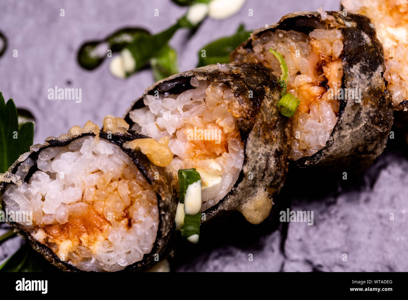 Sushi Roll viewed from above. On black stone Stock Photo - Alamy
