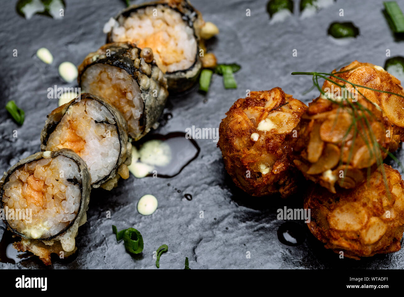 Sushi Roll viewed from above. On black stone Stock Photo - Alamy
