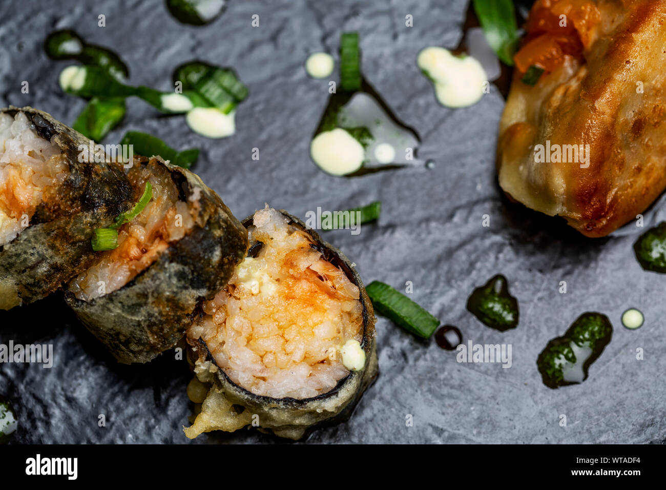 Sushi Roll viewed from above. On black stone Stock Photo - Alamy
