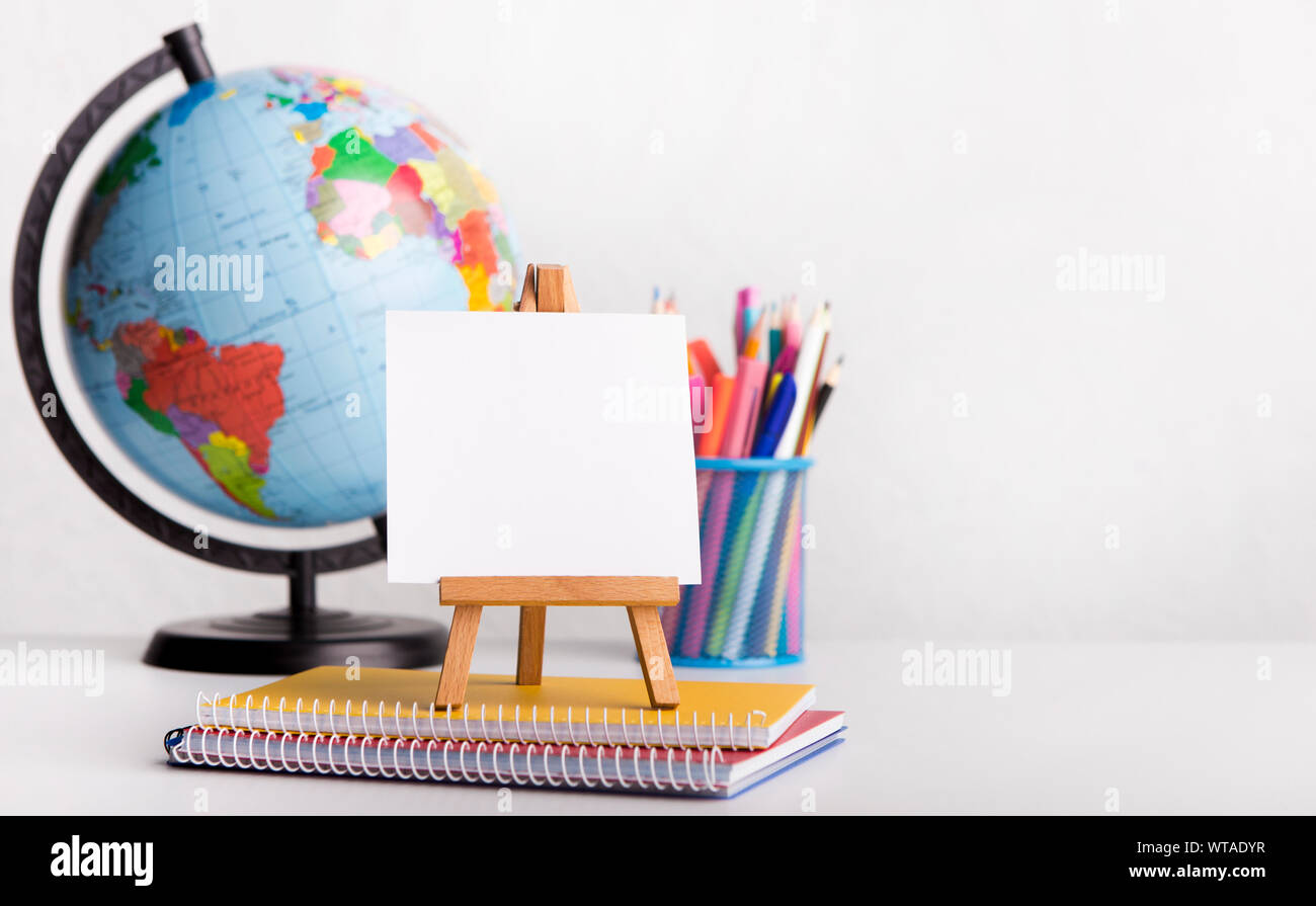Small easel with clear sheet of paper and other supplies on white Stock ...