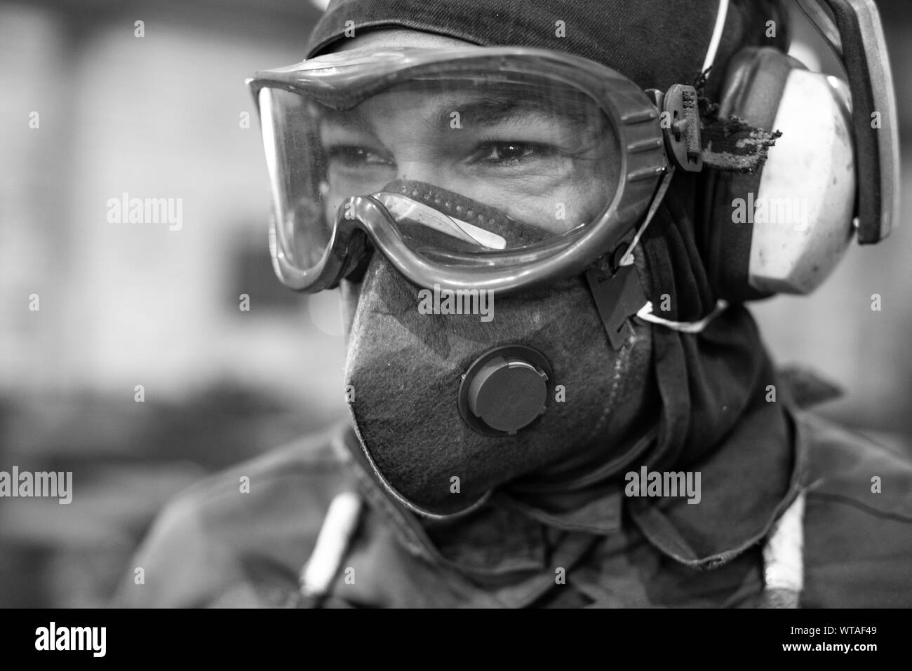 Metallurgical smiling behind work mask Stock Photo - Alamy