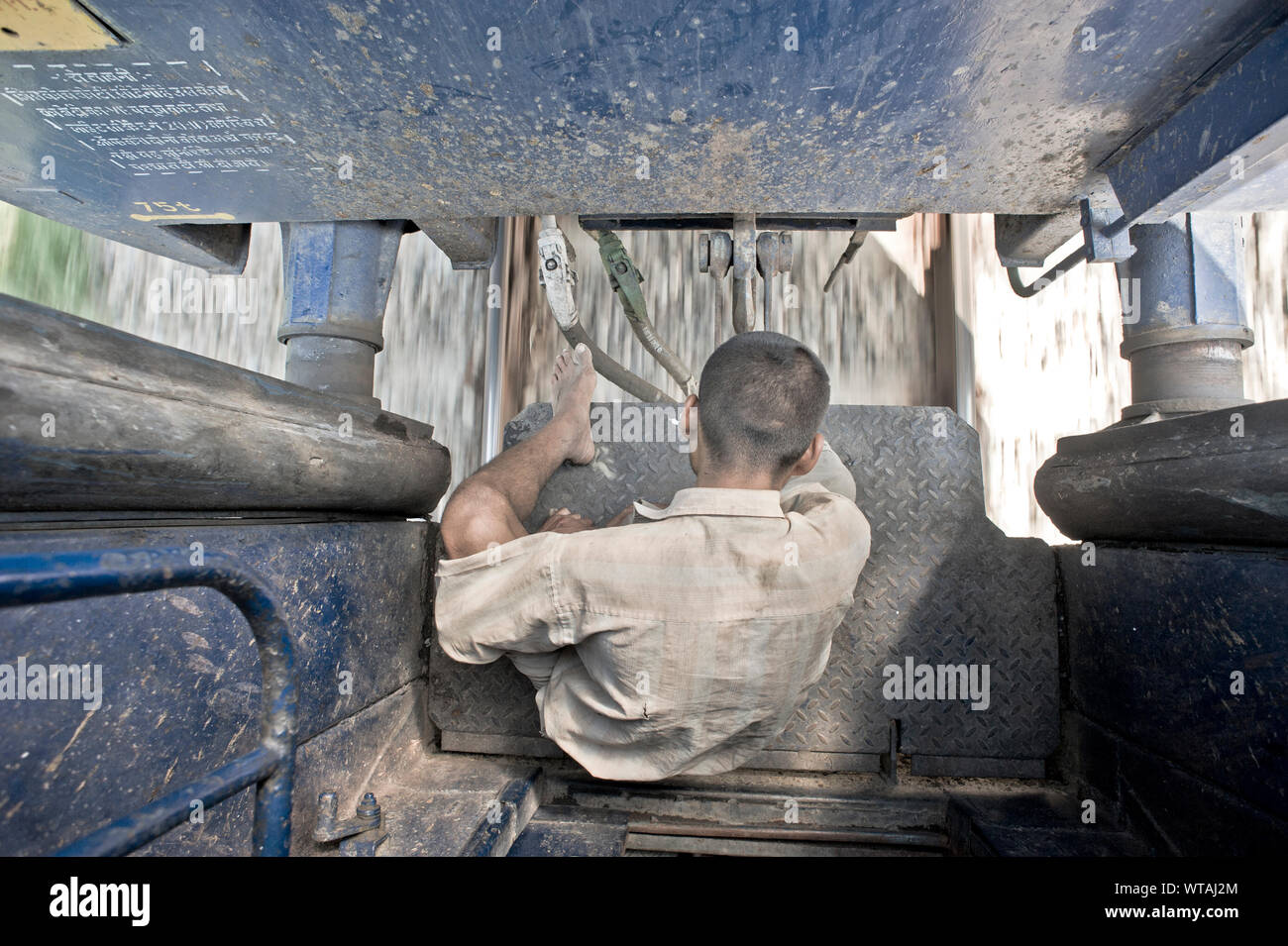 Homeless travelling outside the Indian train Stock Photo - Alamy
