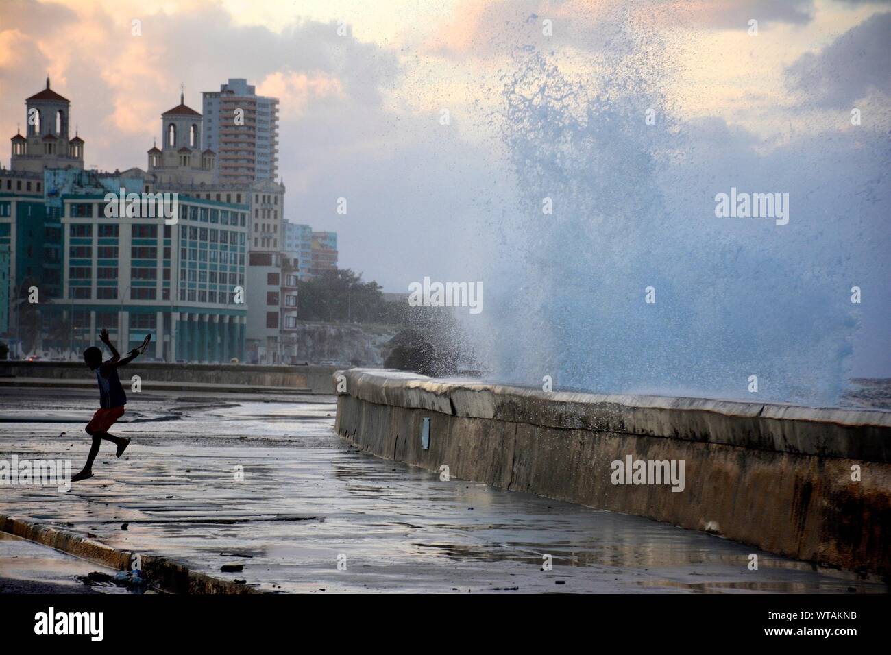 Running in the waves hi-res stock photography and images - Alamy