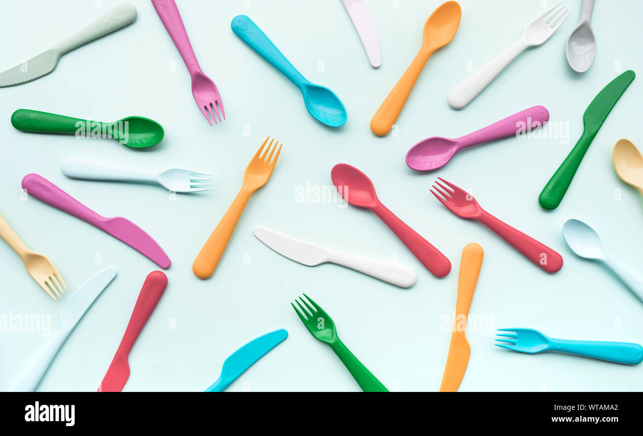 Top view of colorful spoon and fork element on color table.flat lay ...