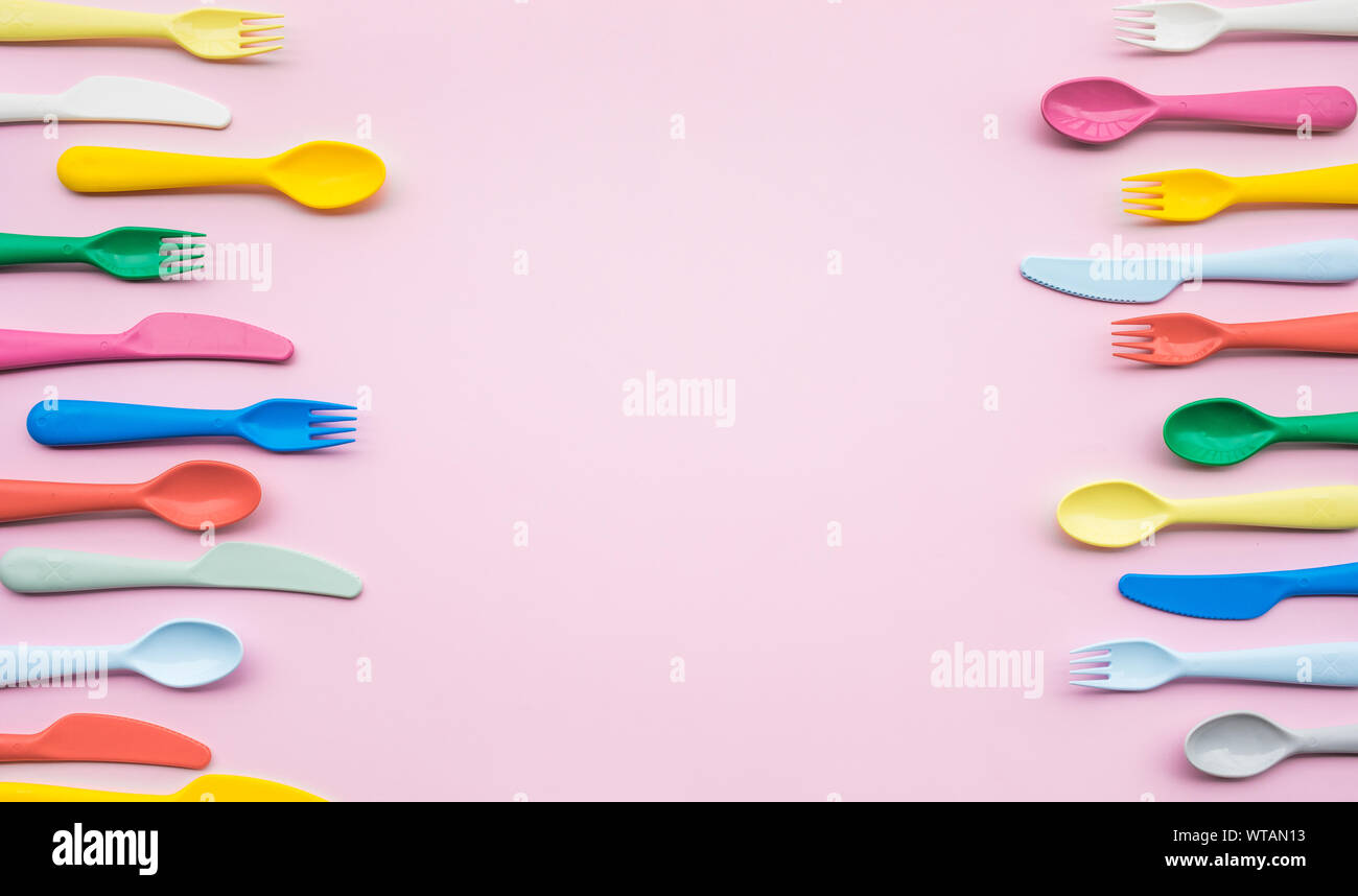 Top view of colorful spoon and fork element on color table.flat lay ...
