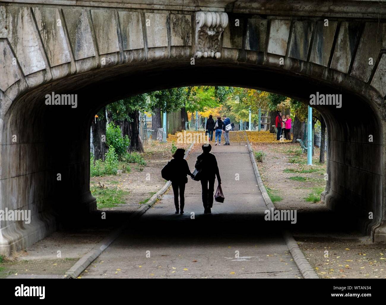 Walking under arch hi-res stock photography and images - Alamy