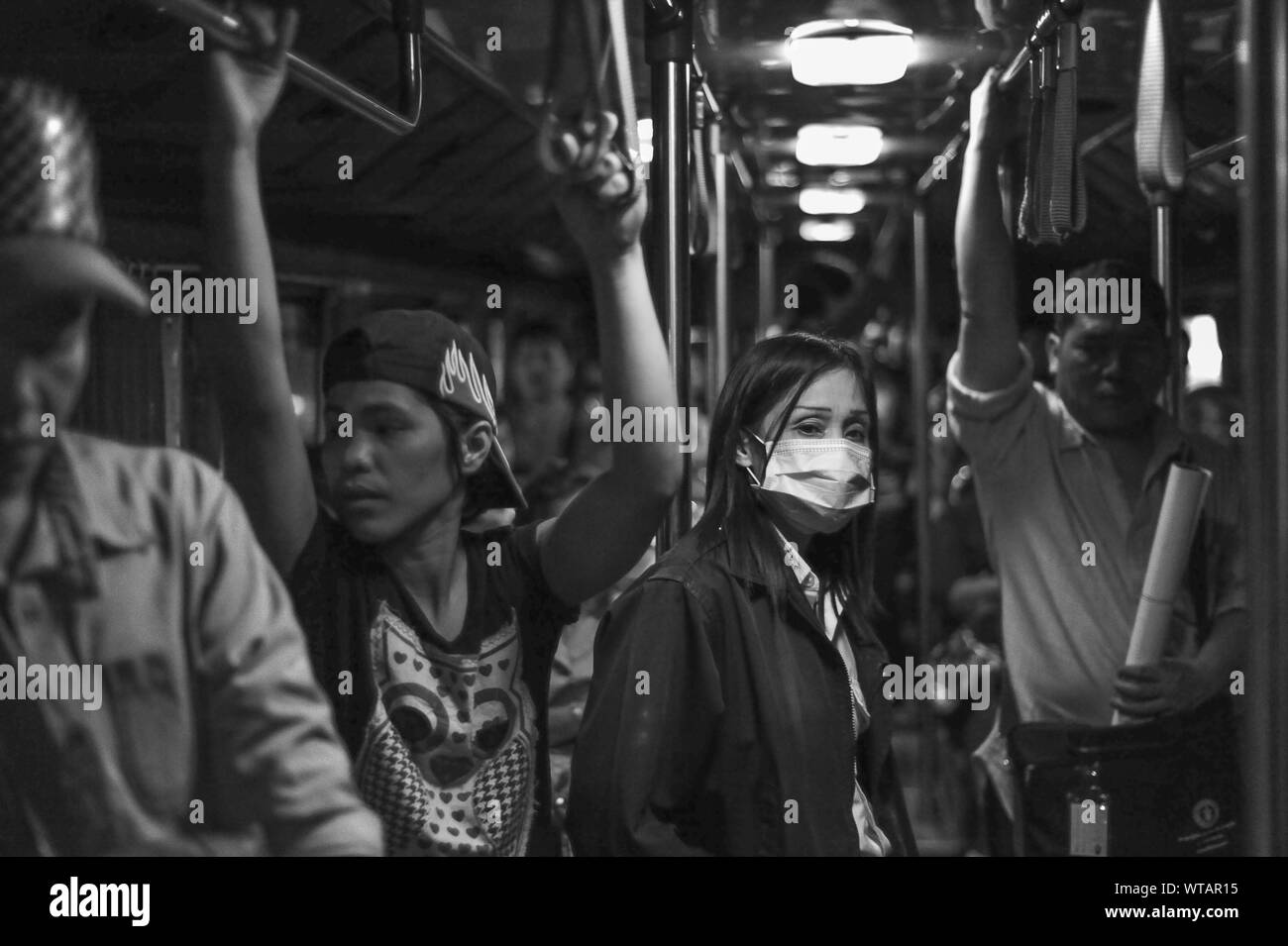 Ticket collector using anti-pollution mask inside a public bus Stock ...