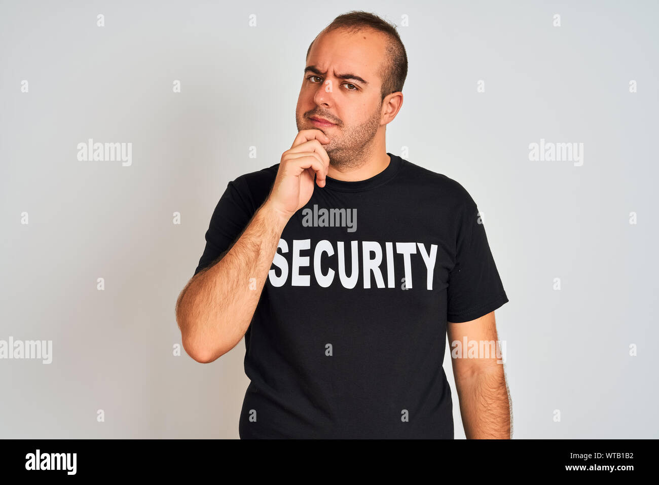 Young safeguard man wearing security uniform standing over isolated ...