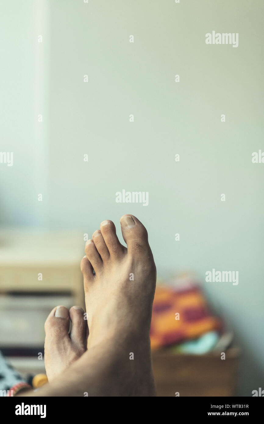 Caucasian male feet resting on a nap on an indoor home background Stock ...