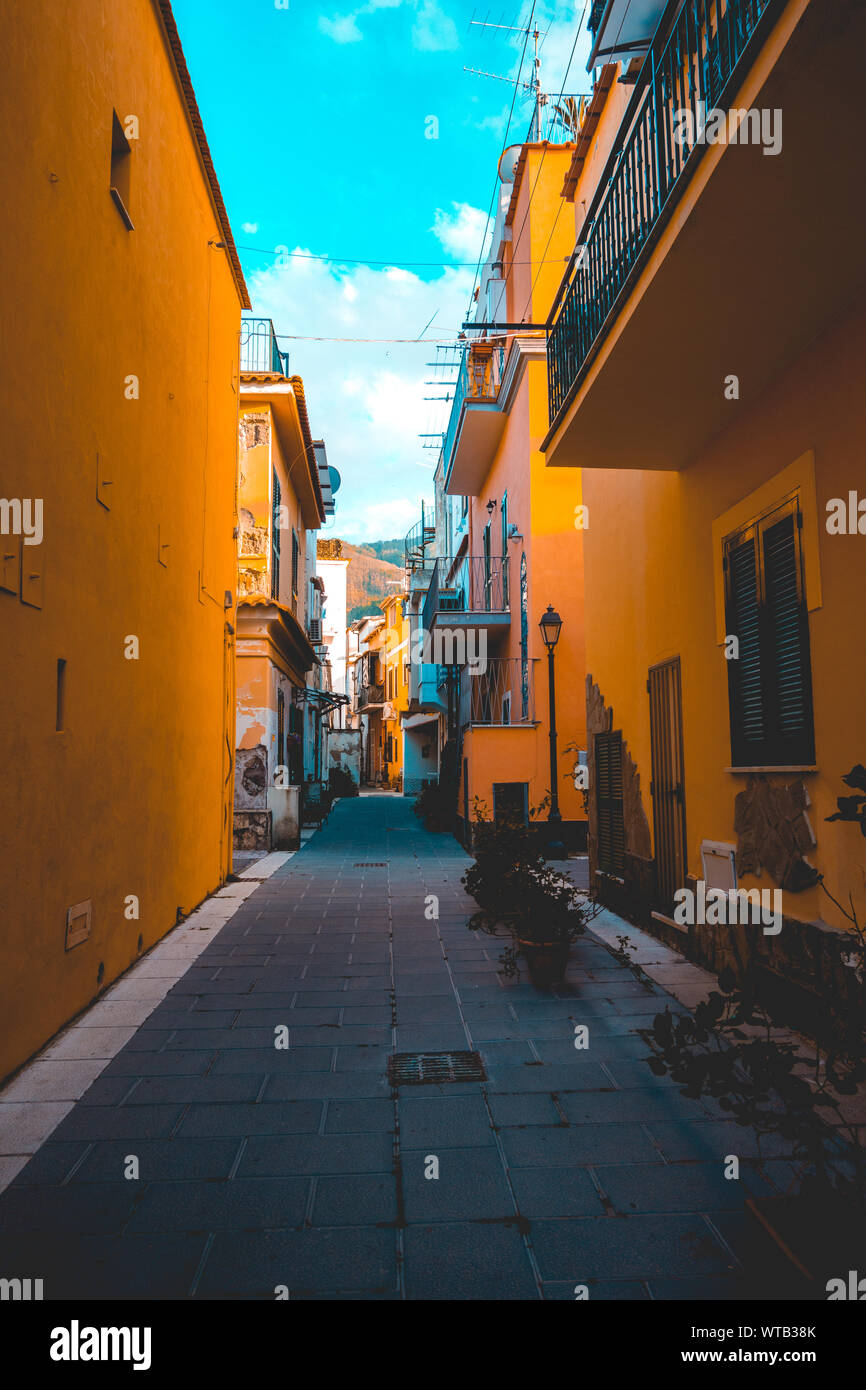 orange buildings in a lone street Stock Photo - Alamy
