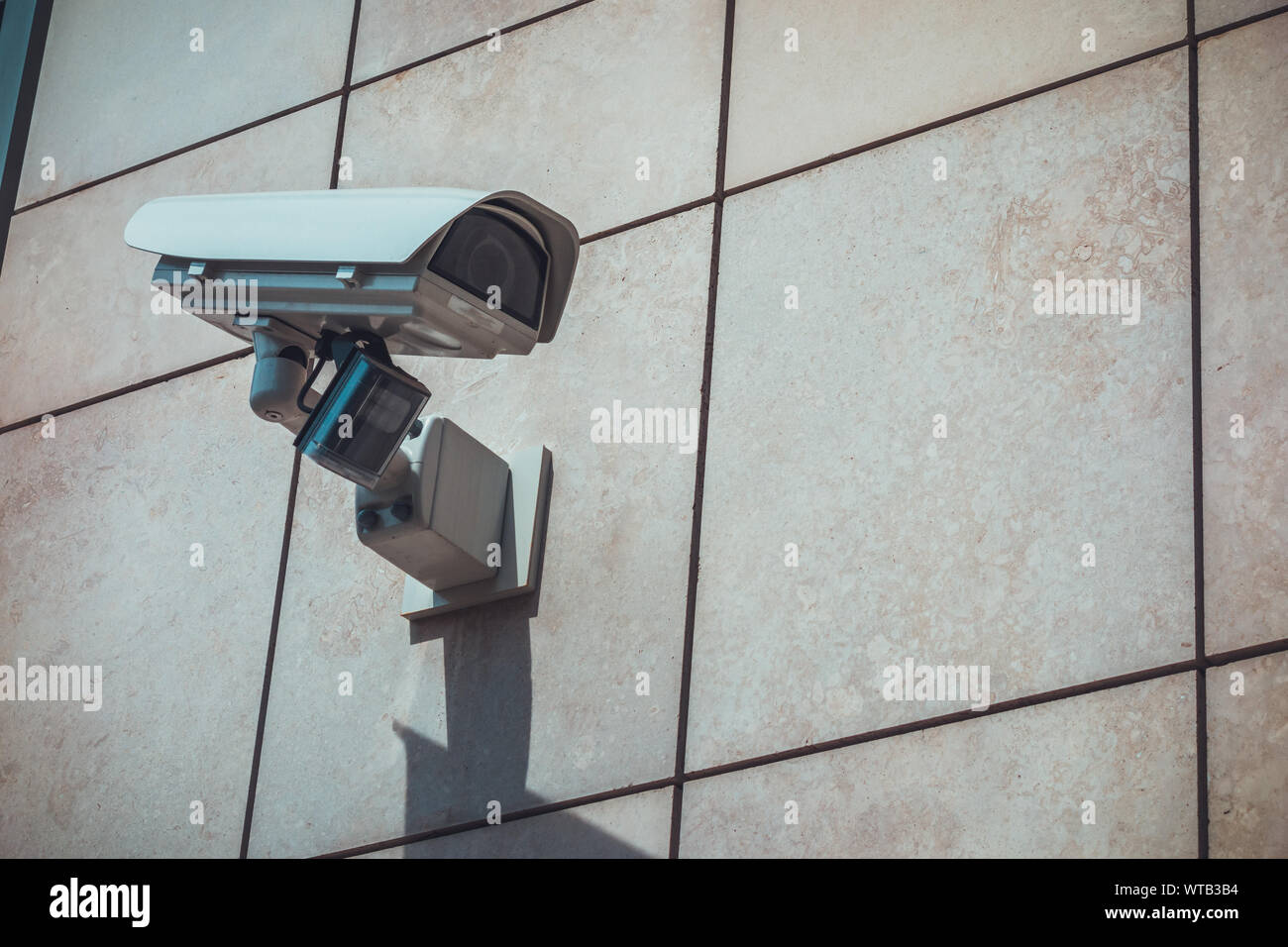 security camera on grey facade Stock Photo - Alamy