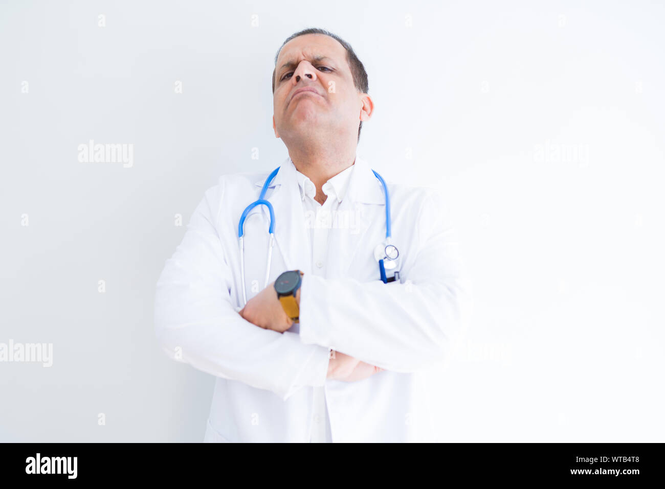 Middle age doctor man wearing stethoscope and medical coat over white ...