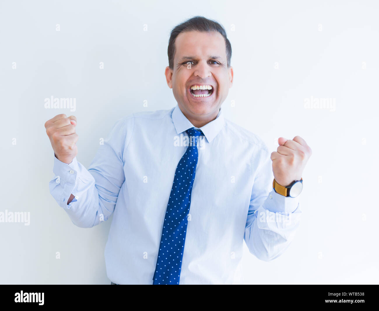 Middle age business man celebrating and screaming happy for succesful ...