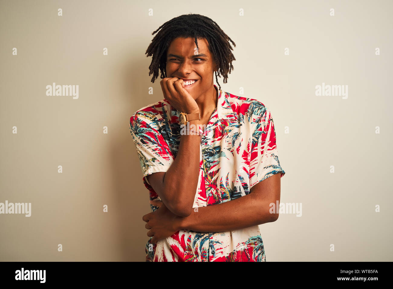 Afro man with dreadlocks on vacation wearing summer shirt over isolated ...