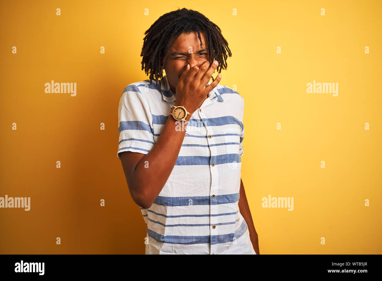 Afro american man with dreadlocks wearing striped shirt over isolated ...
