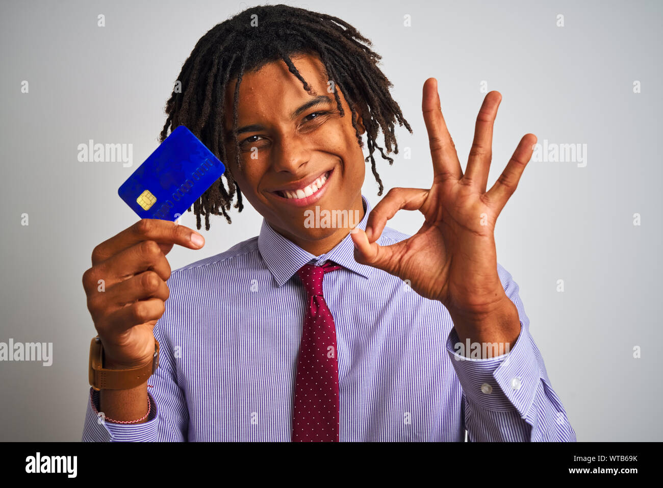 Afro american businessman with dreadlocks holding credit card over ...
