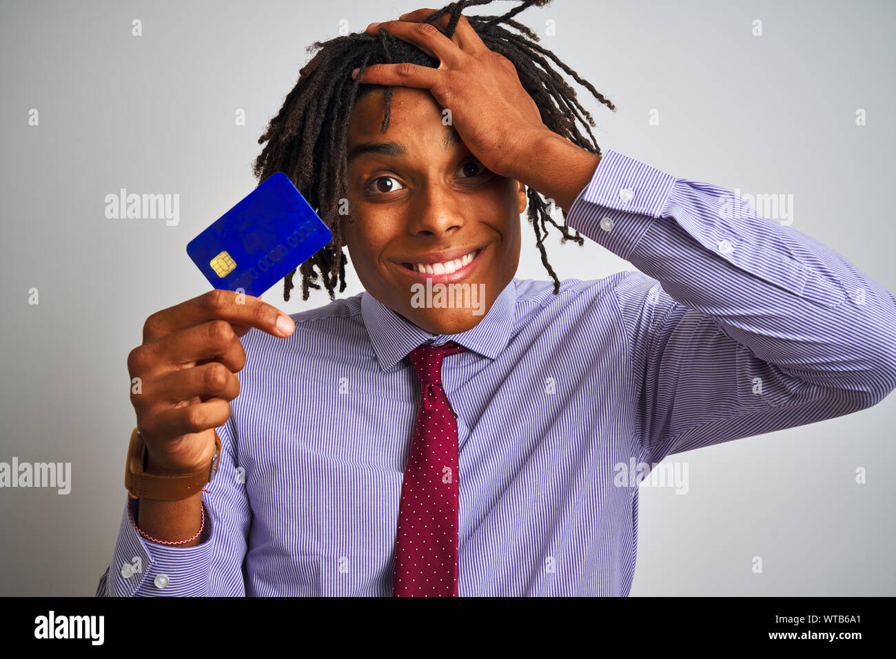 Afro american businessman with dreadlocks holding credit card over ...