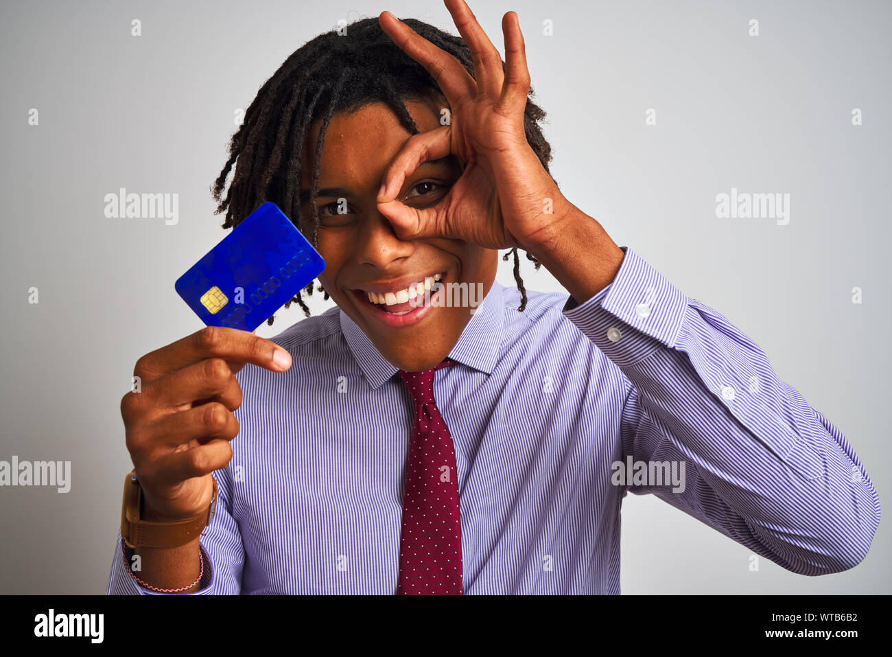 Afro american businessman with dreadlocks holding credit card over ...