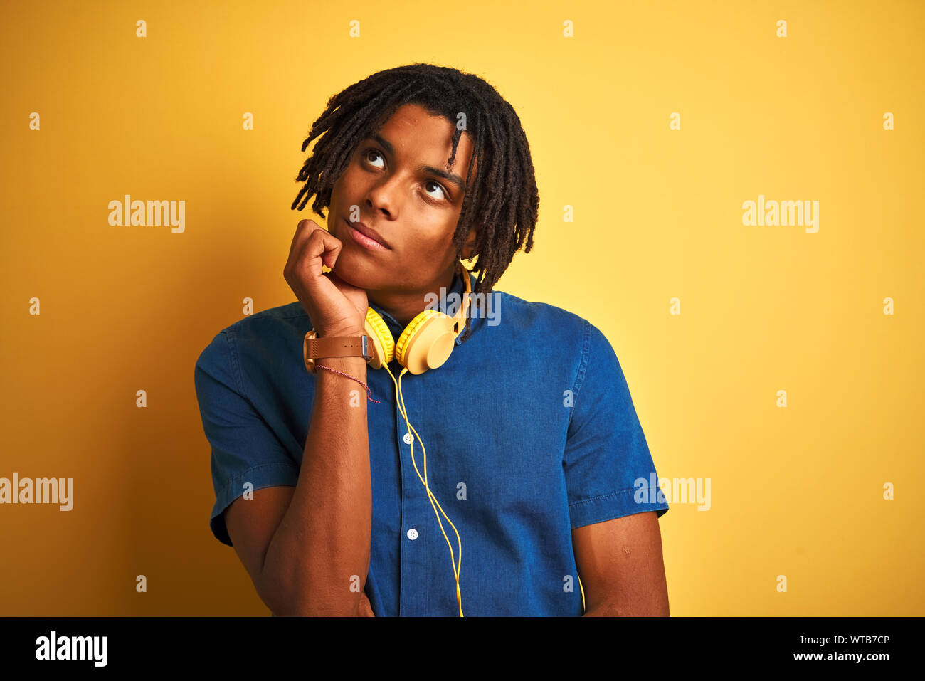 Afro american man with dreadlocks wearing headphones over isolated ...