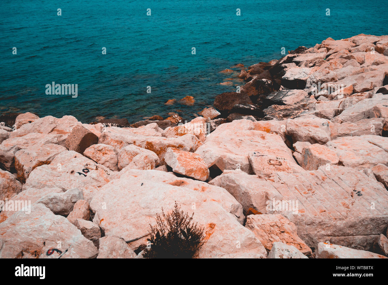 rocks at the ocean in cold colors Stock Photo - Alamy