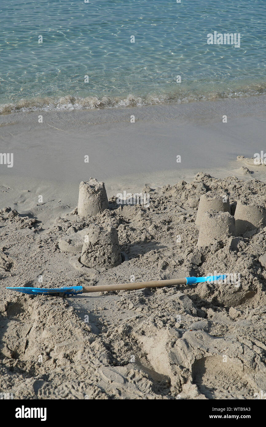 Sandcastles and spade on the beach Stock Photo - Alamy