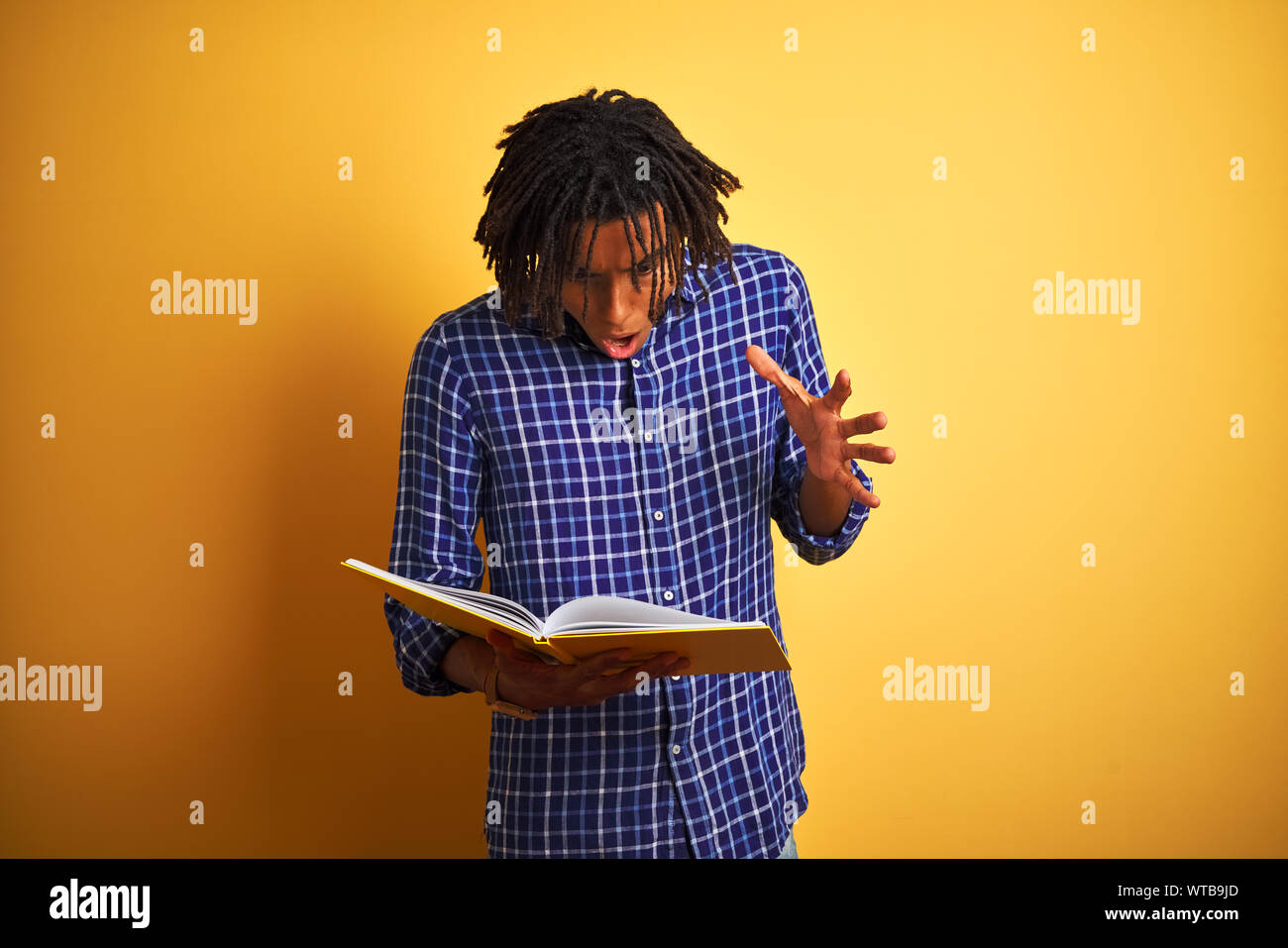 Afro american student man with dreadlocks reading book over isolated ...