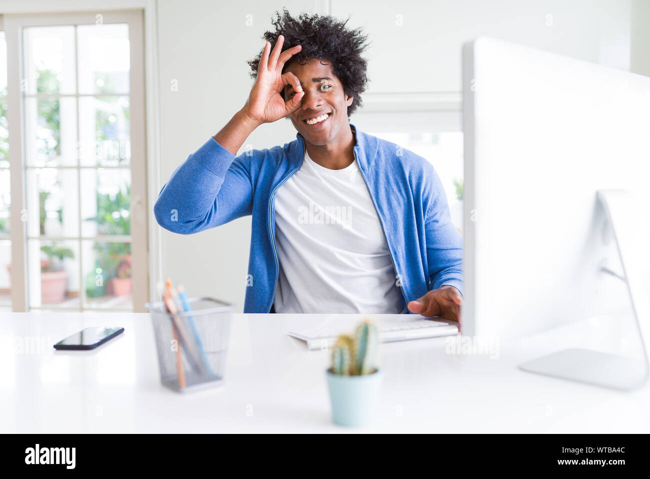 African American man working using computer with happy face smiling ...