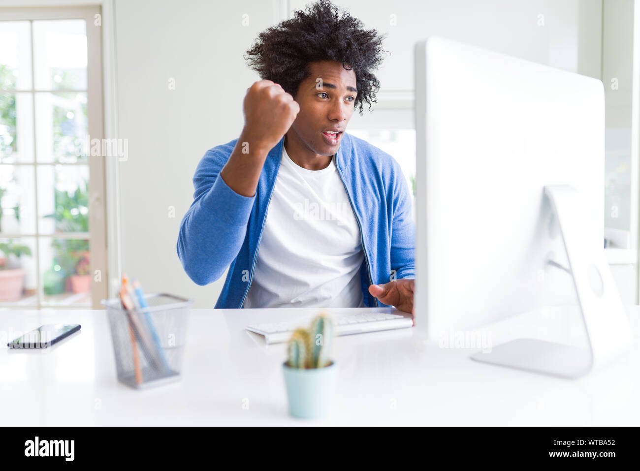 African American man working using computer annoyed and frustrated ...
