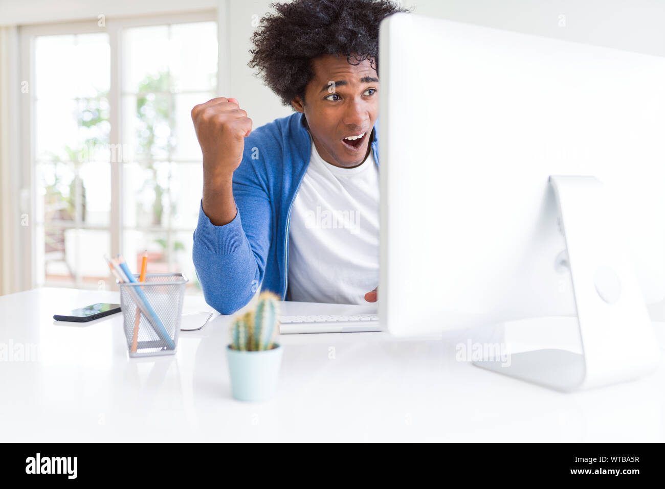 African American man working using computer annoyed and frustrated ...