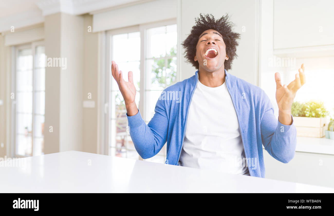 African American man at home celebrating mad and crazy for success with ...