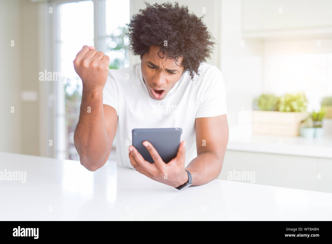 African American man using touchpad table annoyed and frustrated ...