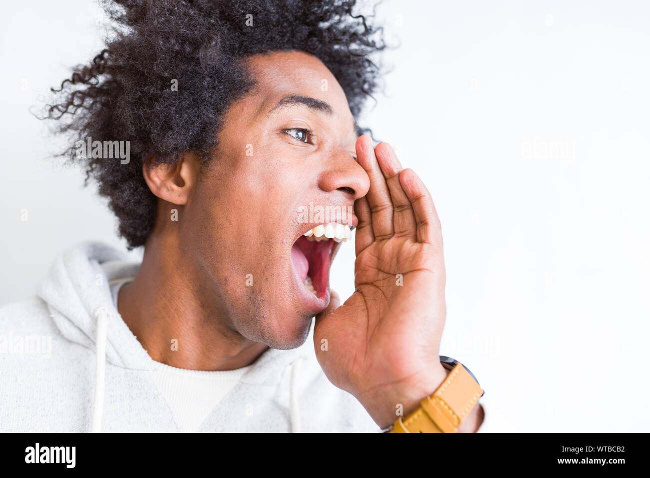 African American man over white isolated background shouting and ...