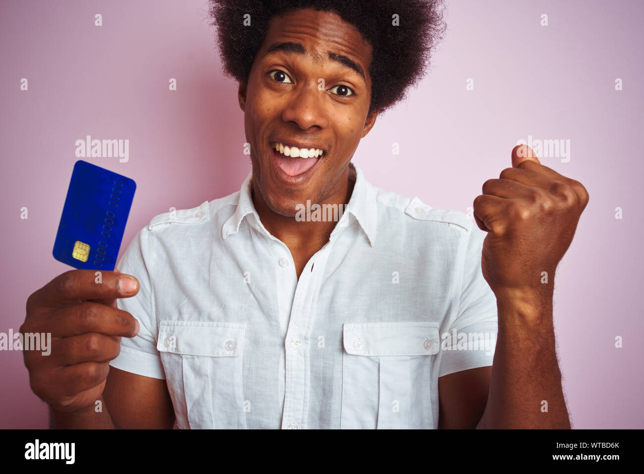 Afro american customer man holding credit card standing over isolated ...