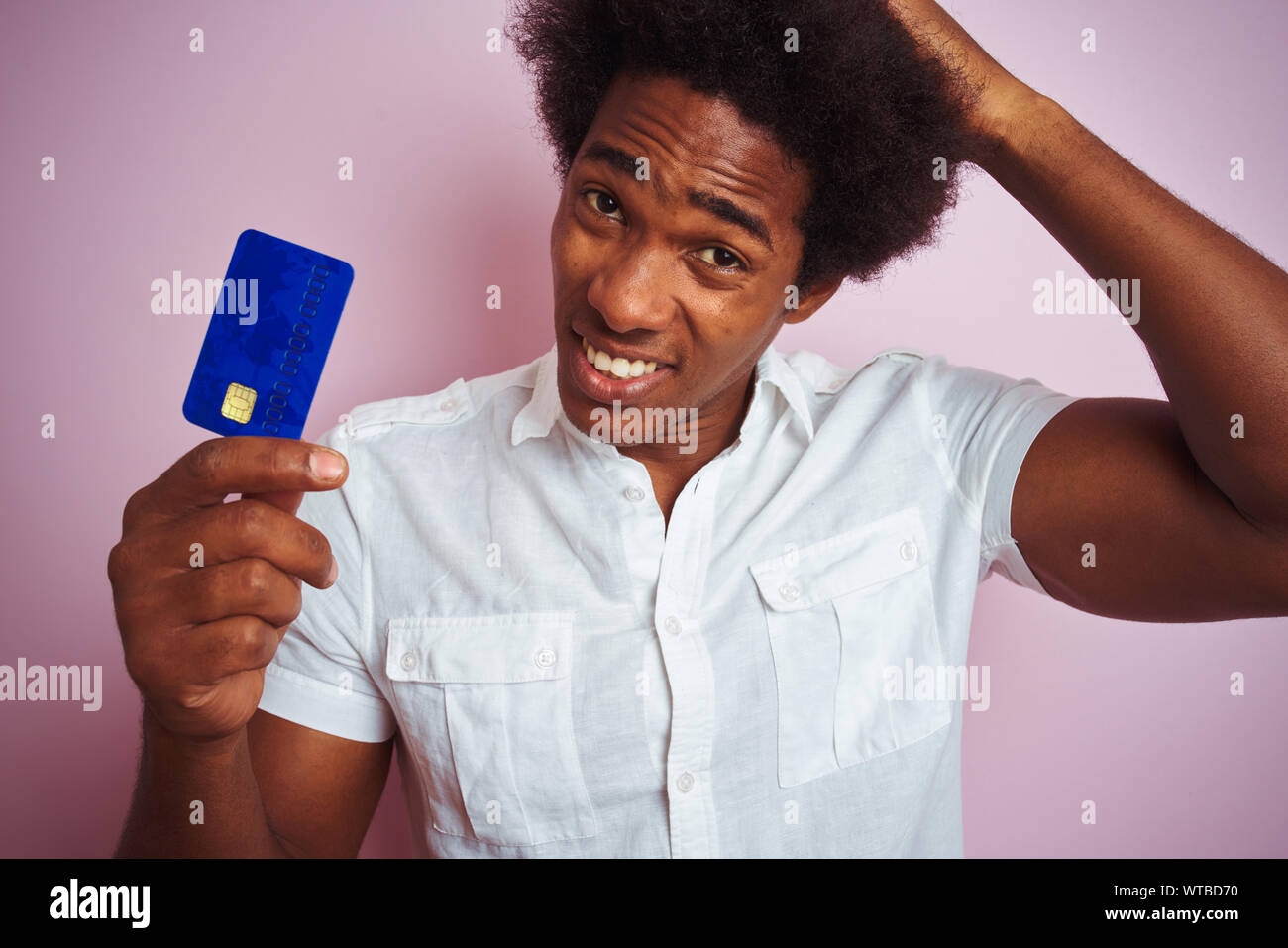 Afro american customer man holding credit card standing over isolated ...