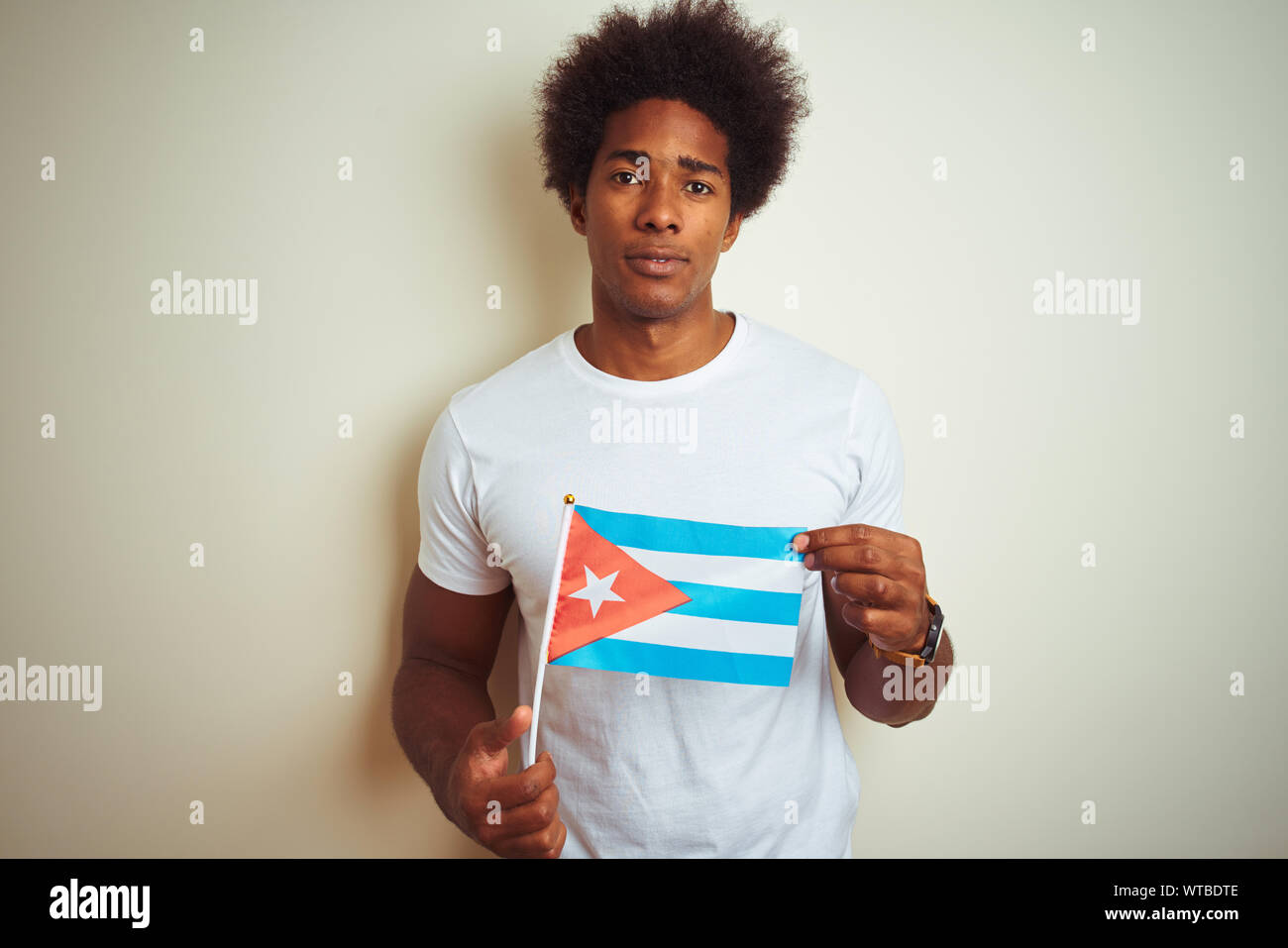 Young african american man holding Cuba Cuban flag standing over ...