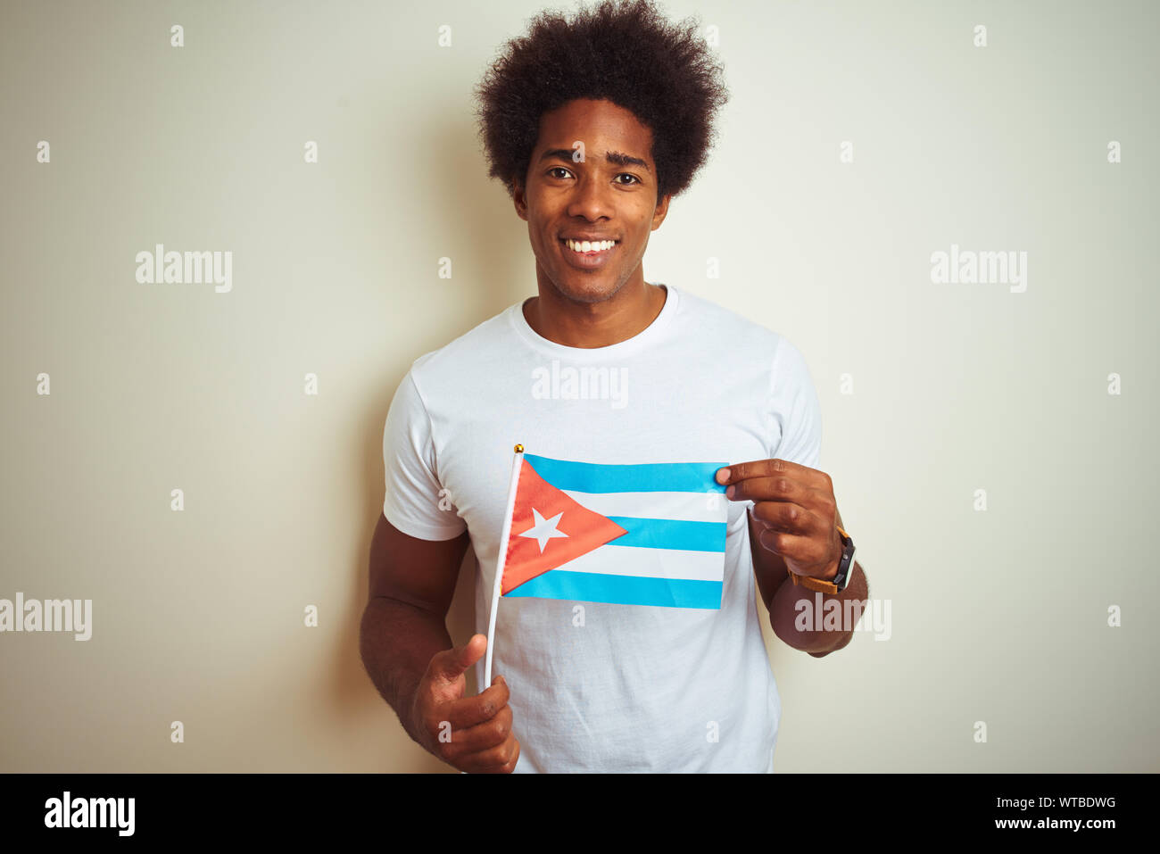 Young african american man holding Cuba Cuban flag standing over ...