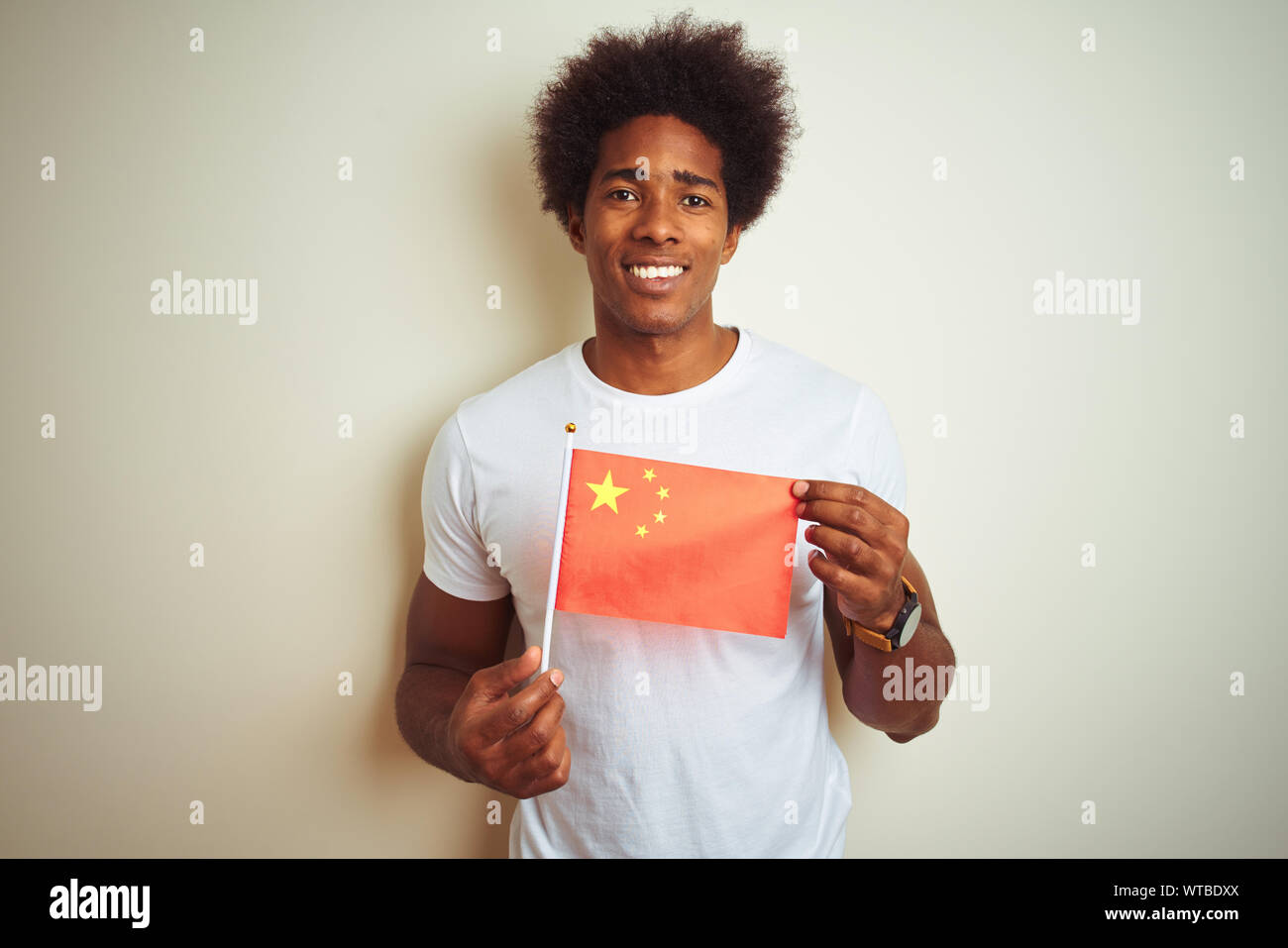 Young afro american man holding China Chinese flag standing over ...