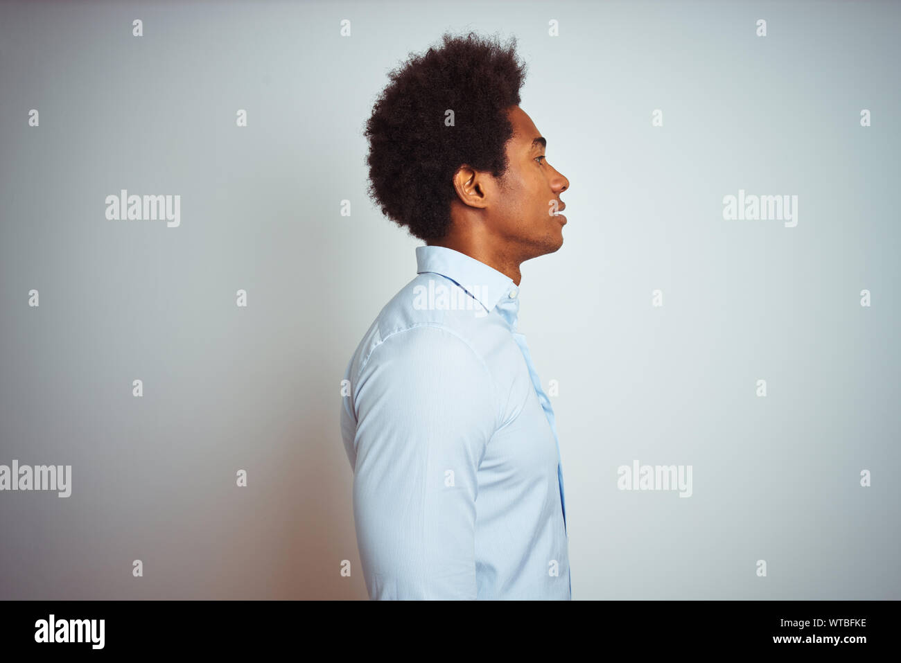 Young african american man with afro hair wearing elegant shirt over ...