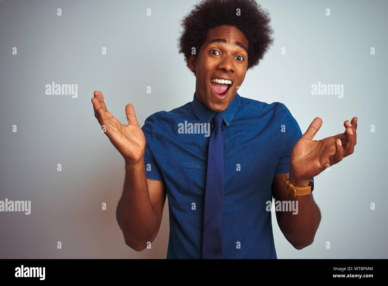 American business man with afro hair wearing blue shirt and tie over ...